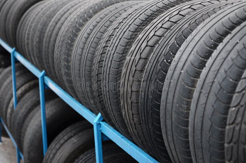 Rack with Variety of Car Tires in Automobile Store. Many Black Tires ...