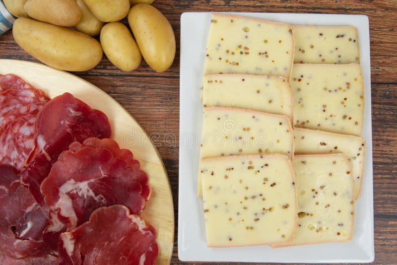 Raclette Cheese and Cold Cuts on a Table Stock Photo - Image of ...