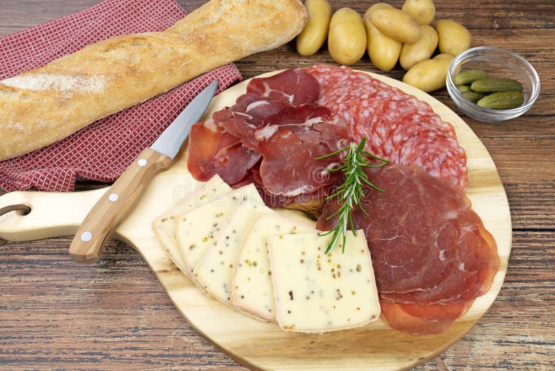 Raclette Cheese and Cold Cuts on a Table Stock Image - Image of board ...