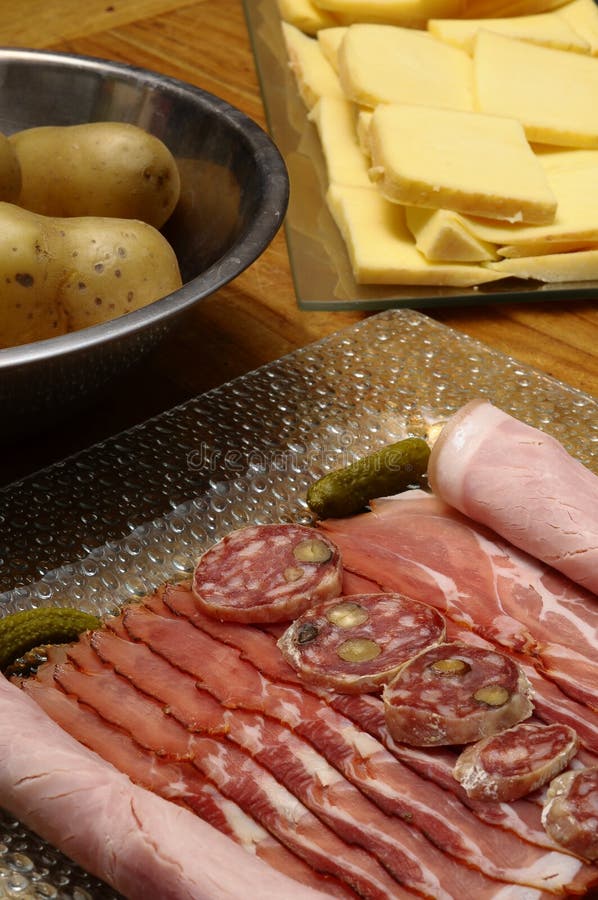 Raclette Cheese with Meats (ham, Sausage) and Potatoes Stock Image ...
