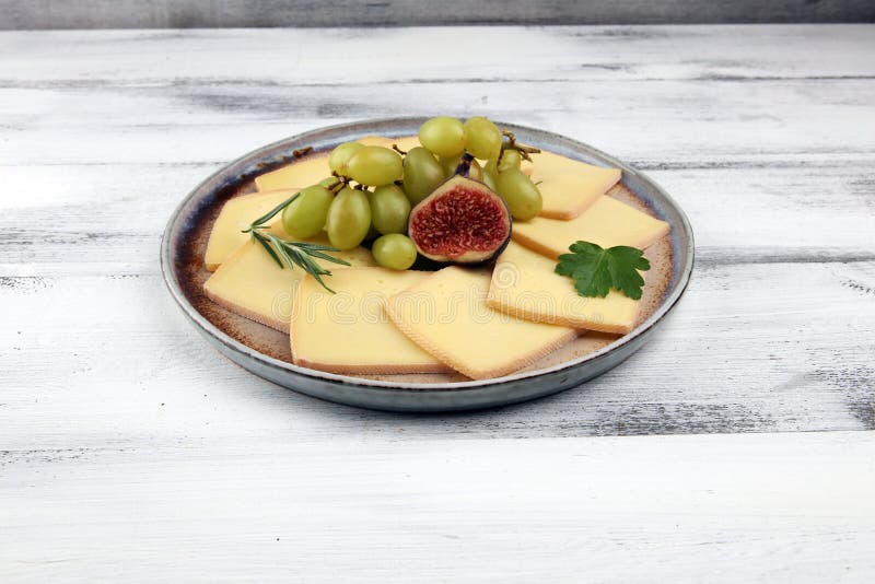 Raclette Cheese Sliced. Very Delicious Swiss Raclette on Rustic ...