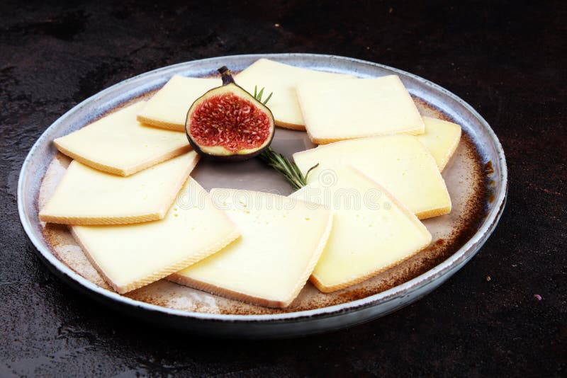 Raclette Cheese Sliced. Very Delicious Swiss Raclette on Rustic ...