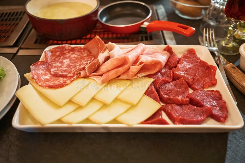 Raclette Cheese and Various Cold Meats Stock Image - Image of brunch ...