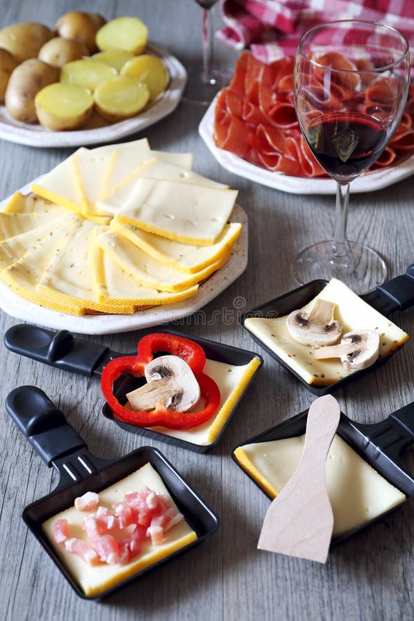 Raclette Party with Cheese, Potato and Meat Stock Photo - Image of ...