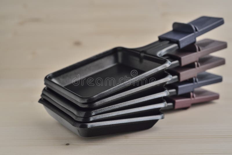 Raclette trays stock image. Image of dinnerware, gourmet - 64340553