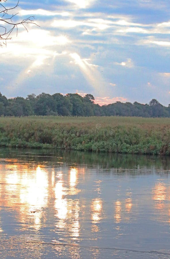 RADIATING SUN REFLECTING in a RIVER Stock Image - Image of scenic ...
