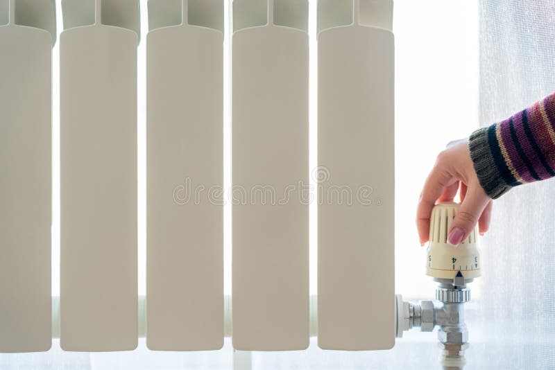 Radiator Adjustment Closeup. Female Hand Adjusting Radiator Temperature ...