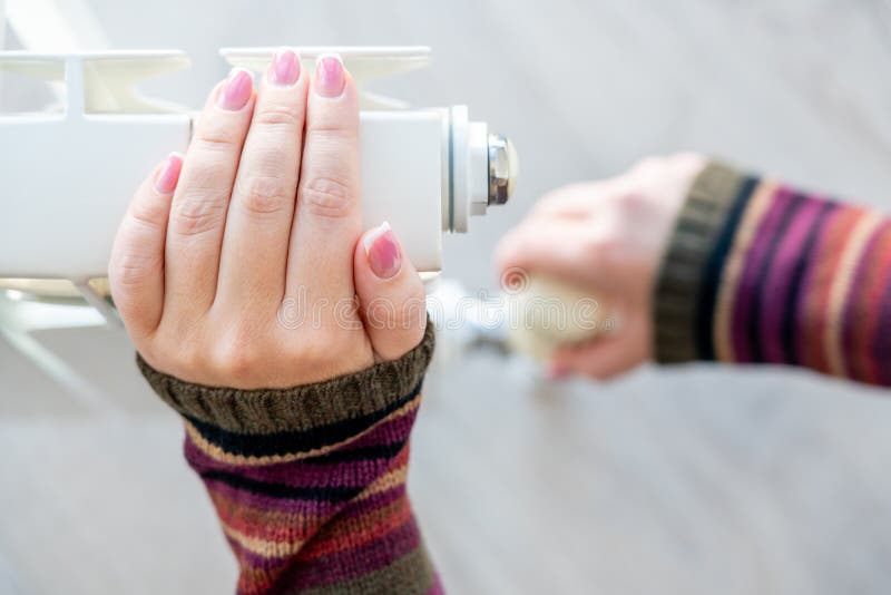 Radiator Adjustment Closeup. Female Hand Adjusting Radiator Temperature ...