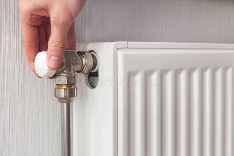 Radiator Adjustment Closeup. Female Hand Adjusting Radiator Temperature ...