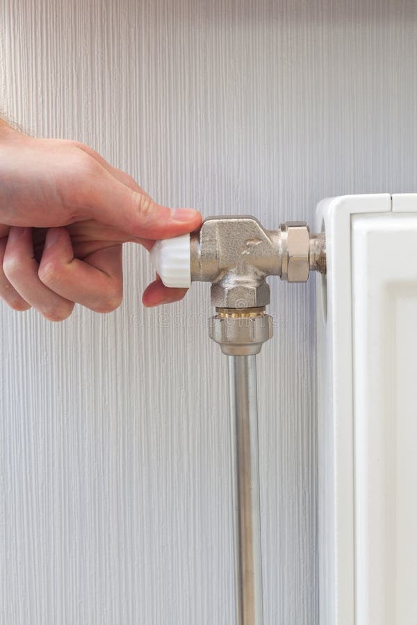 Radiator Adjustment Closeup. Female Hand Adjusting Radiator Temperature ...