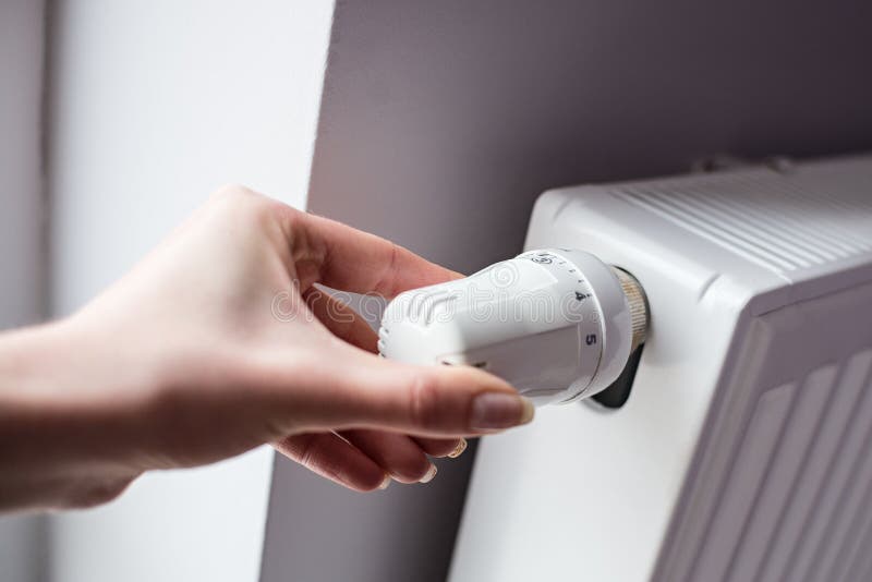 Radiator Adjustment Closeup. Female Hand Adjusting Radiator Temperature ...