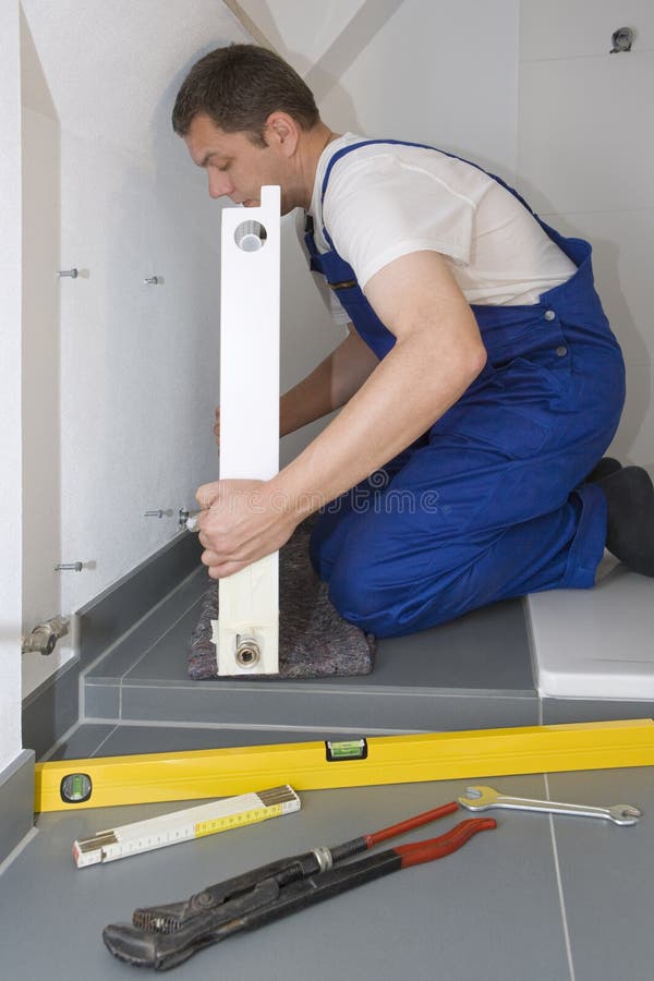 Radiator installation stock photo. Image of fitter, building - 22584422
