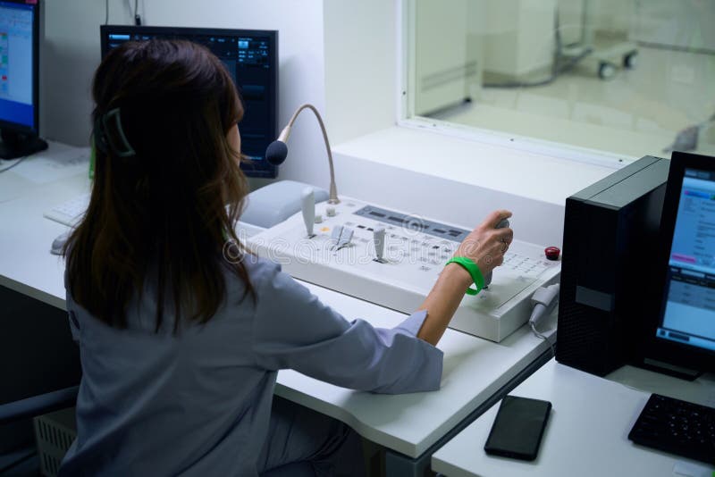 Radiographer Communicating Remotely with Patient from Control Room ...