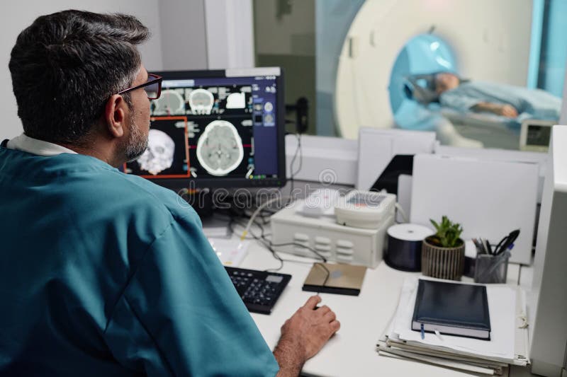 Radiographer Controlling CT Scanner at Work in Hospital Stock Photo ...