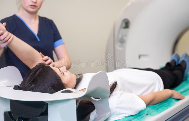 Radiologic Technician and Patient Being Scanned and Diagnosed on ...