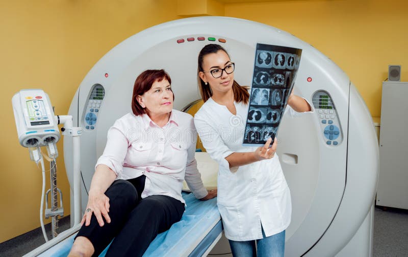 Radiologist with an Elderly Female Patient Looking at X-ray. Stock ...