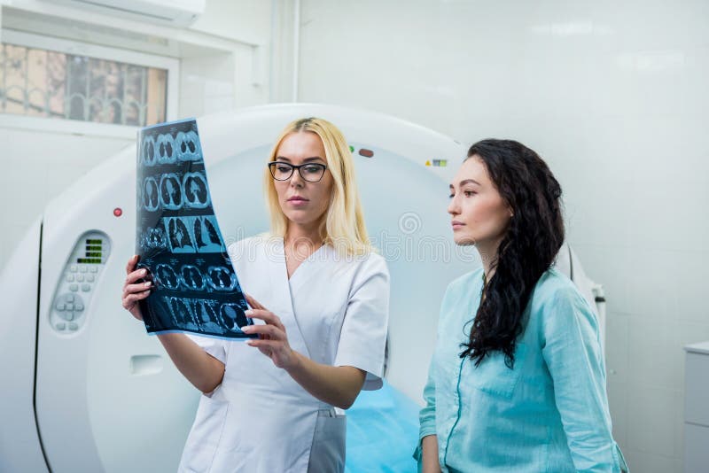 Radiologist with a Female Patient Examining a CT Scan Stock Image ...