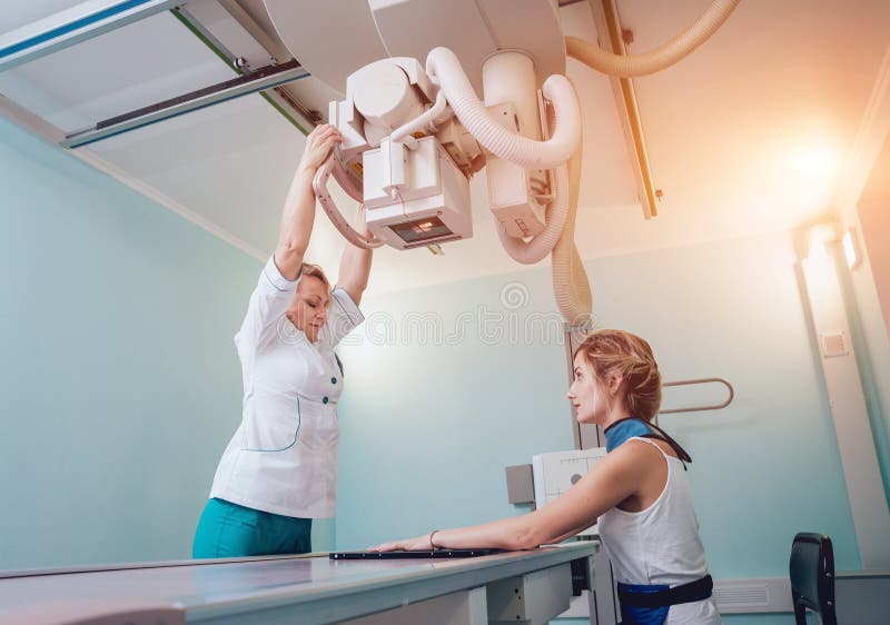Radiologist and Patient in a X-ray Room. Classic Ceiling-mounted X-ray ...