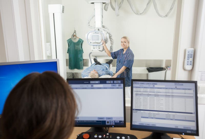 Radiologist Taking Patient's Xray Colleague Using Computer Stock Photos ...
