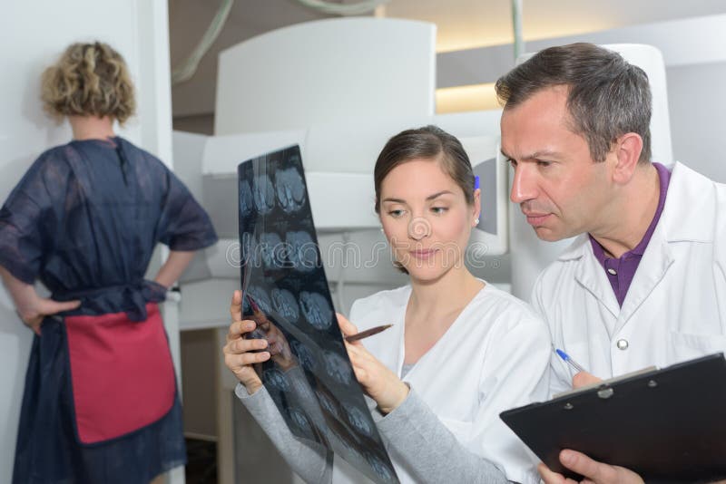 Radiologist Woman Checking X-ray with Co-worker Stock Photo - Image of ...
