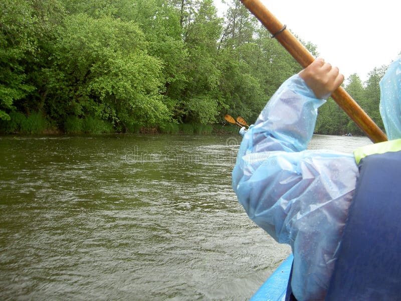 Rafting on the Calm River. Paddle in the Hand of a Man in a Blue ...