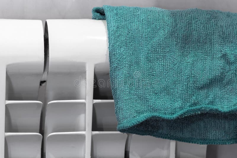Rag on the heating battery stock photo. Image of maid - 189390524
