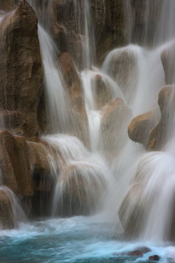 Raging Waterfalls Surrounded by Rocks Stock Photo - Image of energy ...