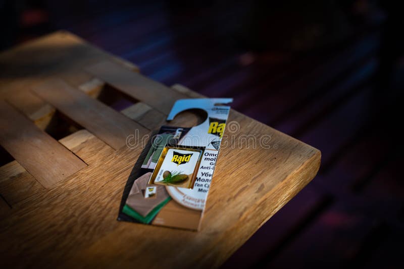 Raid Insecticide in Package on Oak Patio Table. Editorial Photography ...