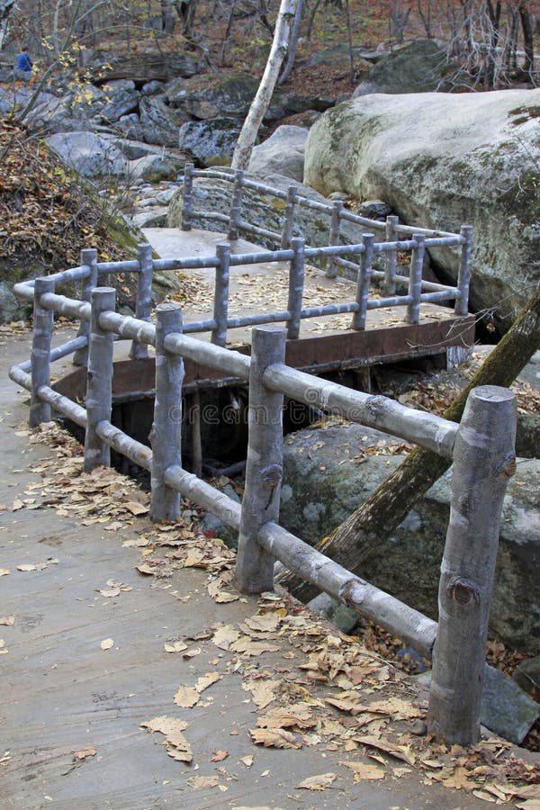 Rail and rock in the park stock photo. Image of landscape - 386950002