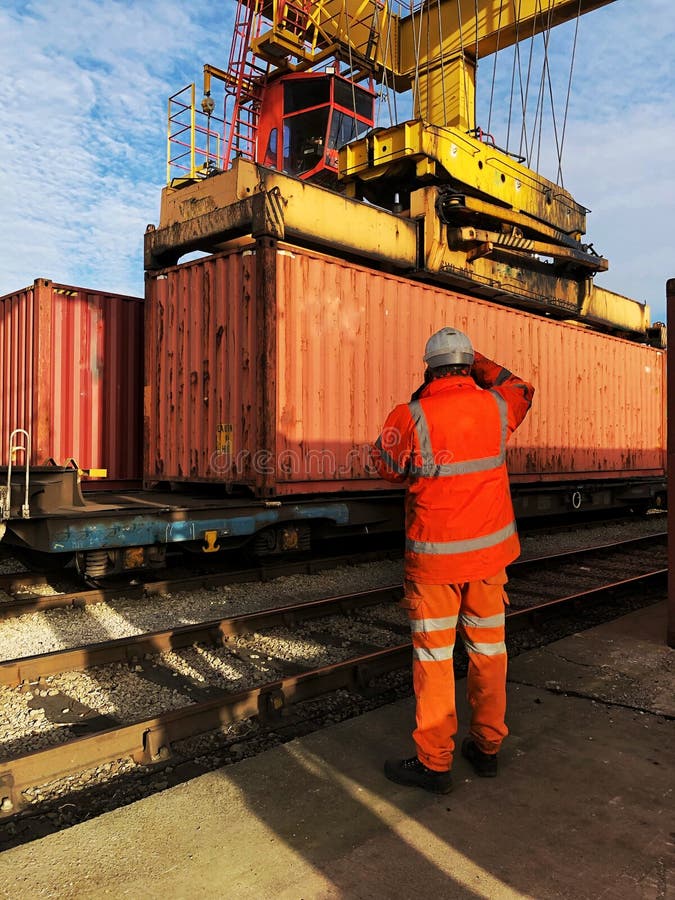 Rail Worker Loading Shipping Container Onto Freight Train with Crane ...