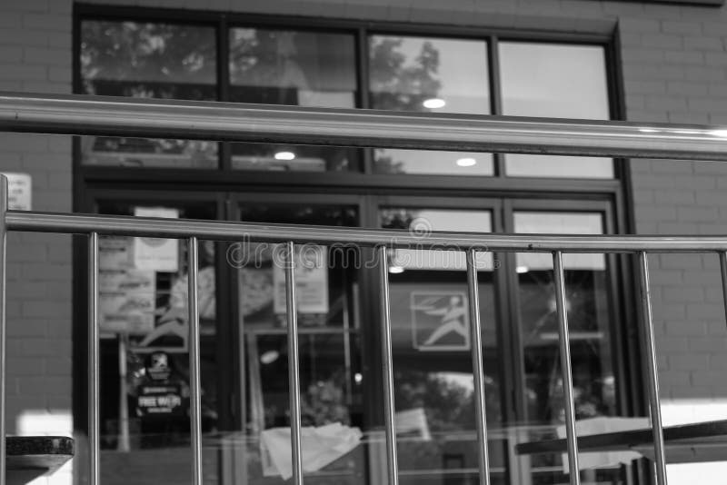Railing Outside a Pizza Spot Stock Photo - Image of spot, monochrome ...