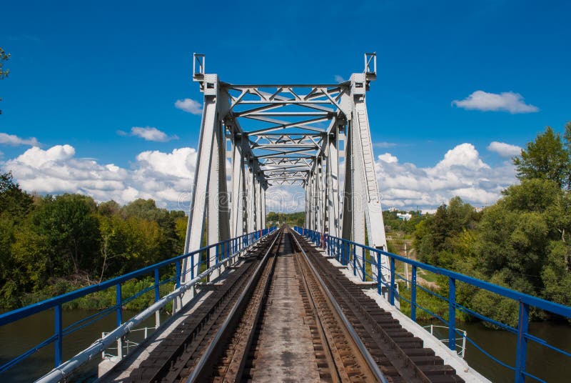Railroad Bridge View on Background with Green Trees and Blue Cloudy Sky ...