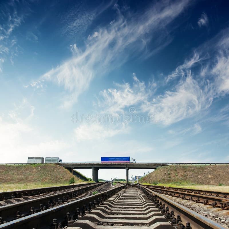 Railroad Closeup and Bridge with Autos Under Blue Sky Stock Image ...