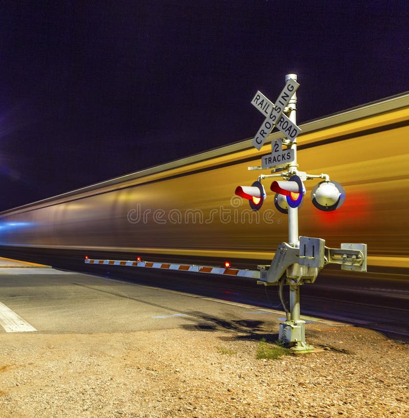Railroad Crossing with Passing Train by Night Stock Photo - Image of ...