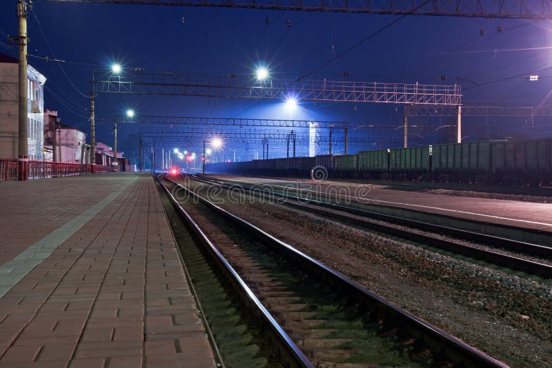 Railroad Night Scene with Blue Traffic Light Stock Photo - Image of ...