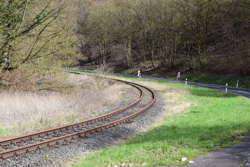 Railroad and Parallel Road Curve in Bold Forest Stock Photo - Image of ...
