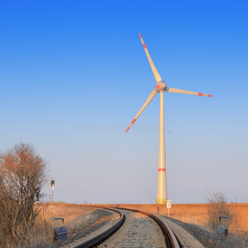 Railroad Towards Modern Windmill Stock Photo - Image of evening ...