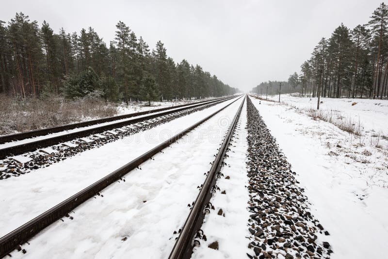 Railroad Tracks in Snowy Winter Day Stock Photo - Image of travel ...