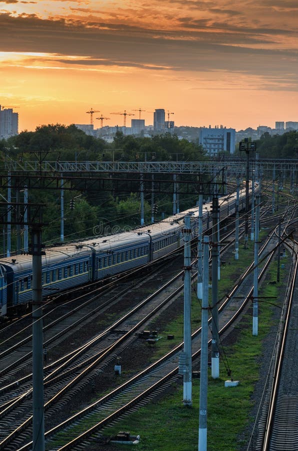 Railroad tracks at sunset stock photo. Image of industry - 100172148