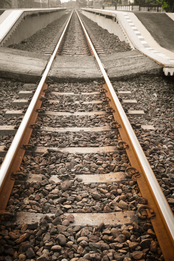 Railroad Tracks in a Train Station and Building Sides for Passengers To ...