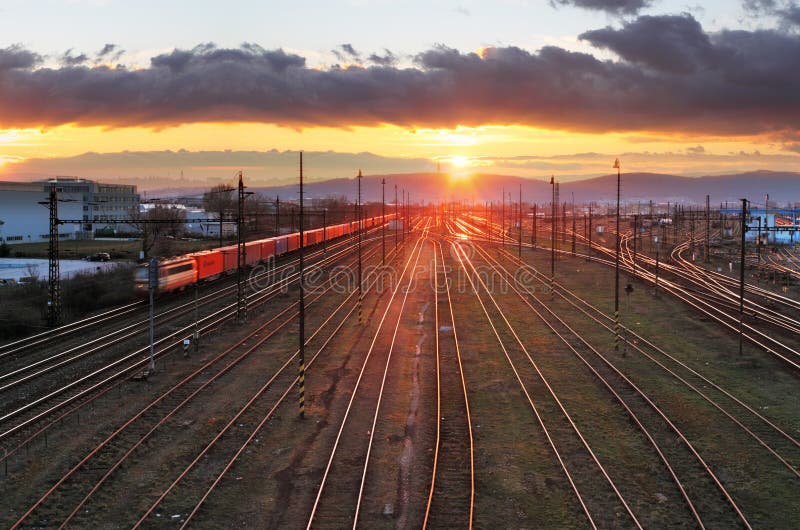 Railroad with Train at Sunset and Many Lines Stock Image - Image of ...