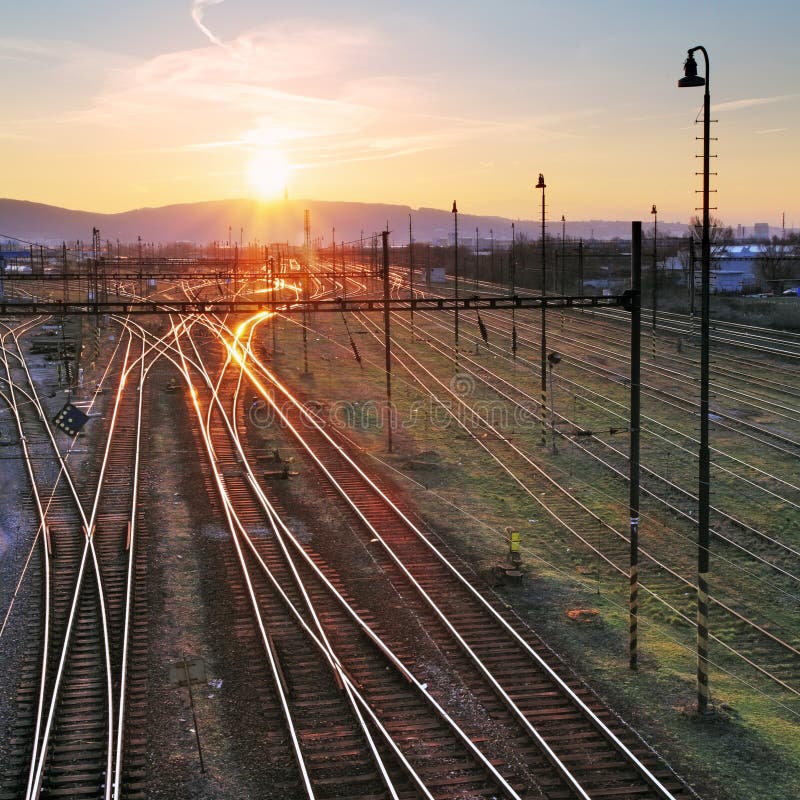 Railroad with Train at Sunset and Many Lines Stock Photo - Image of ...