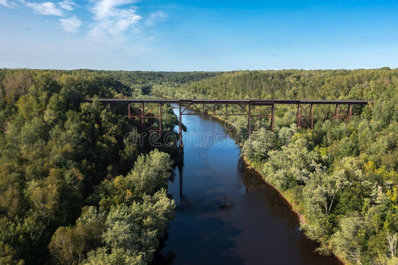 Railroad Trestle Bridge Passes Over River and Forest Stock Image ...