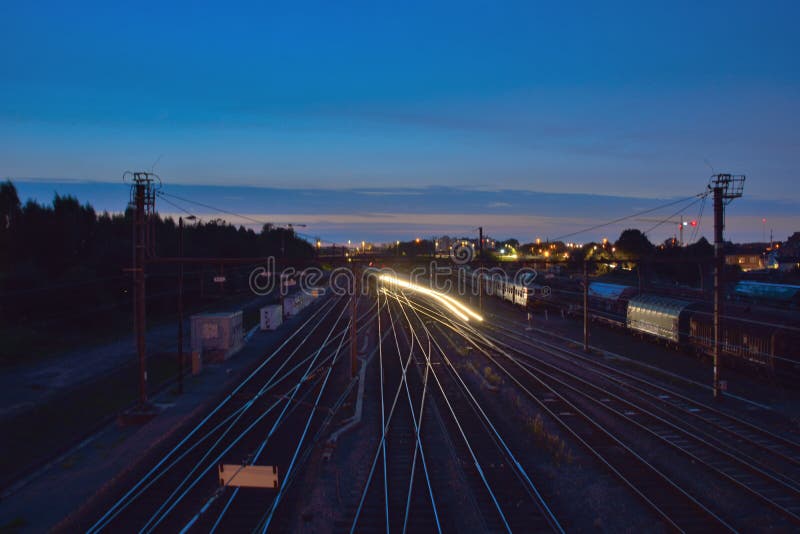 Rails and Passing Train at Night Stock Image - Image of light, outdoors ...