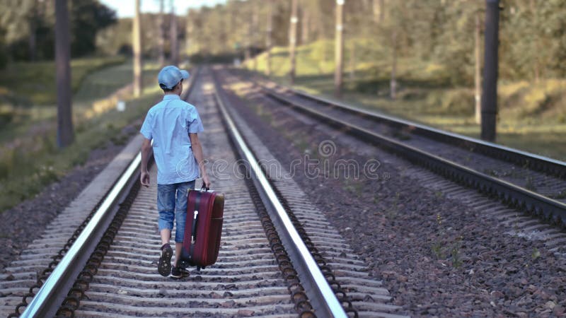 Railway Adventure: Boy with Suitcase Walking on Train Tracks Stock ...