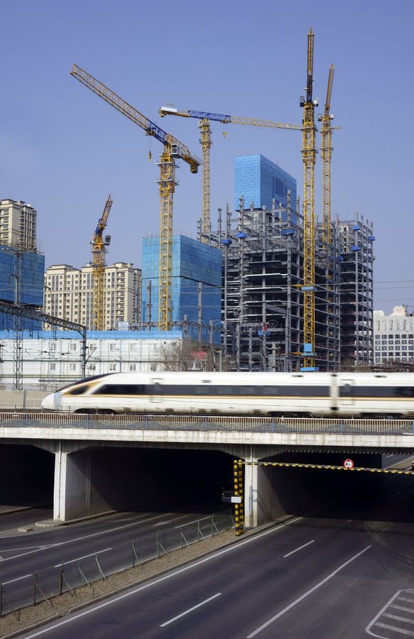 A High-speed Rail Train is Speeding Past a Large Infrastructure Site ...