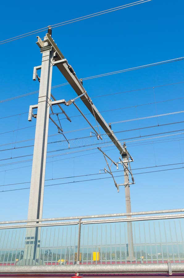 Railway Catenary Against a Blue Sky and Sun Stock Photo - Image of ...