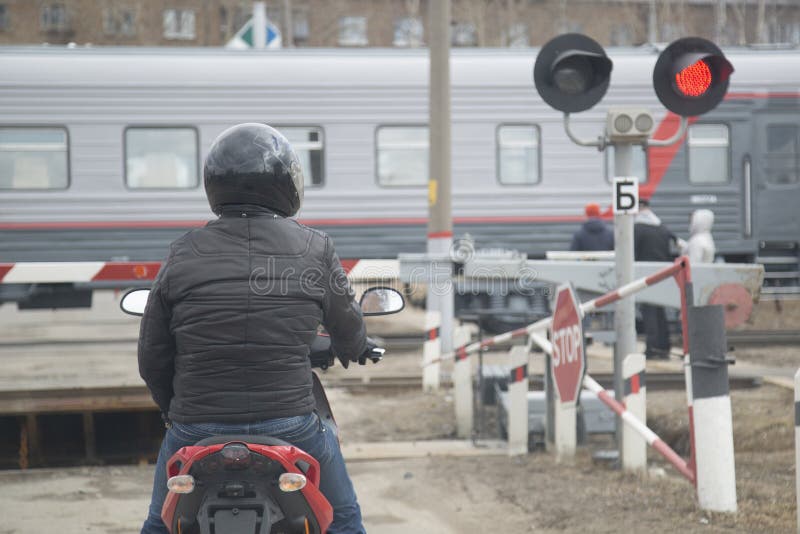 Railway Crossing. Motorcyclist at a Railway Crossing Stock Photo ...