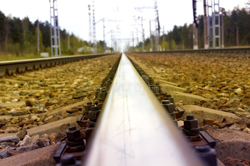 The Railway Rail with Electric Supports Going into the Distance Stock ...