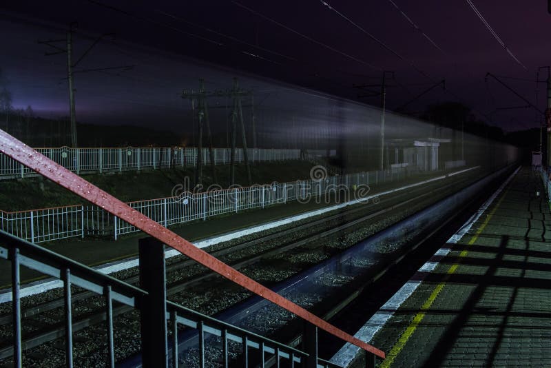 Railway Station at Night with a Passing Train Stock Photo - Image of ...